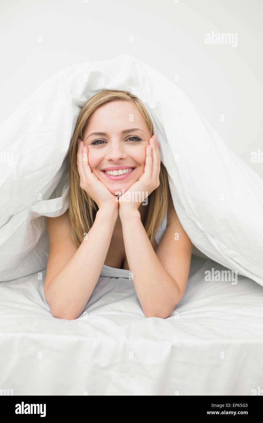Woman lying in bed under sheet hi-res stock photography and images - Alamy