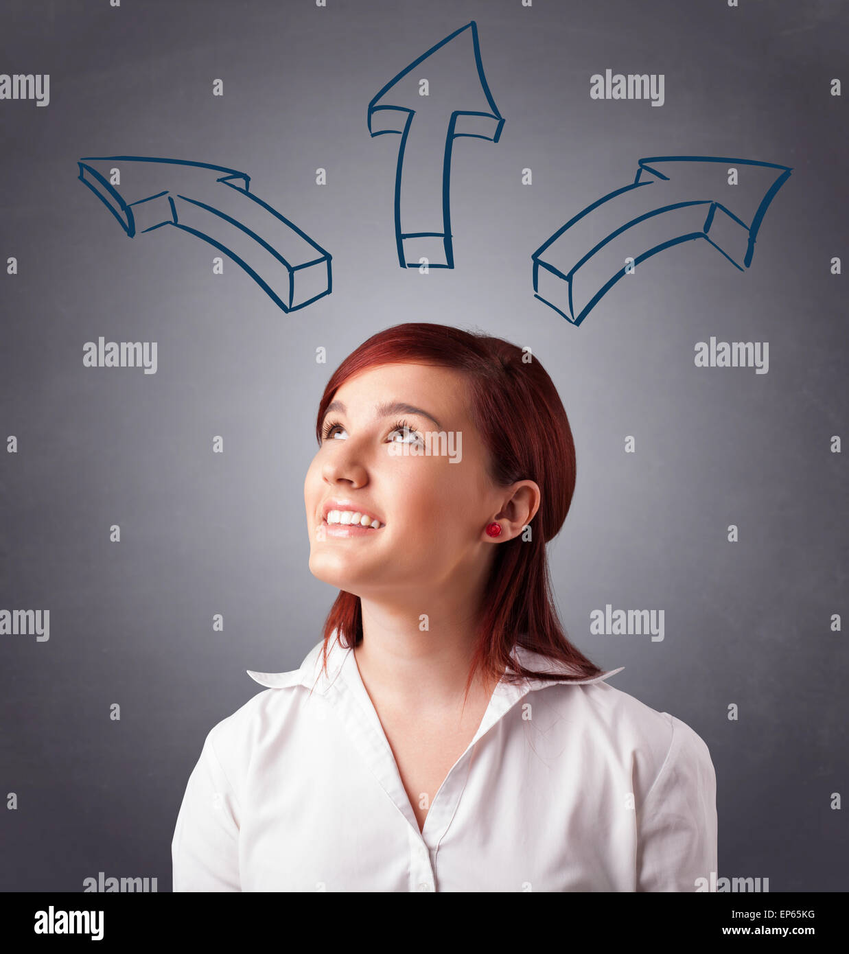 Pretty lady thinking with arrows overhead Stock Photo - Alamy