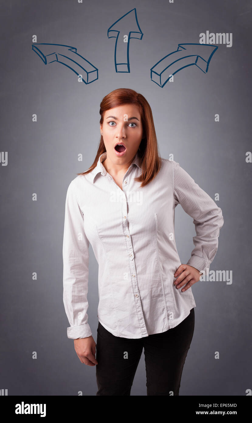 Pretty lady thinking with arrows overhead Stock Photo - Alamy