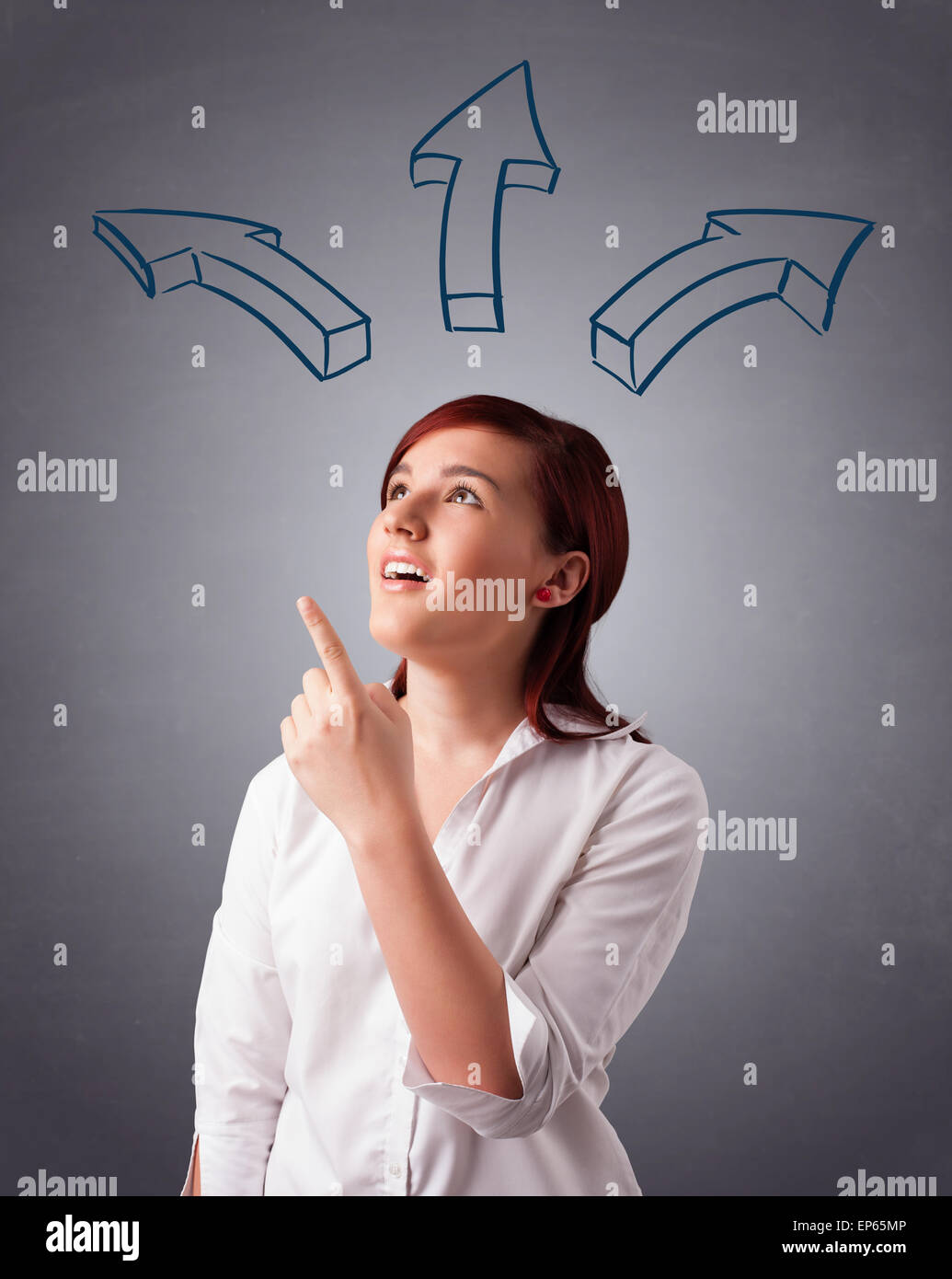Pretty lady thinking with arrows overhead Stock Photo - Alamy