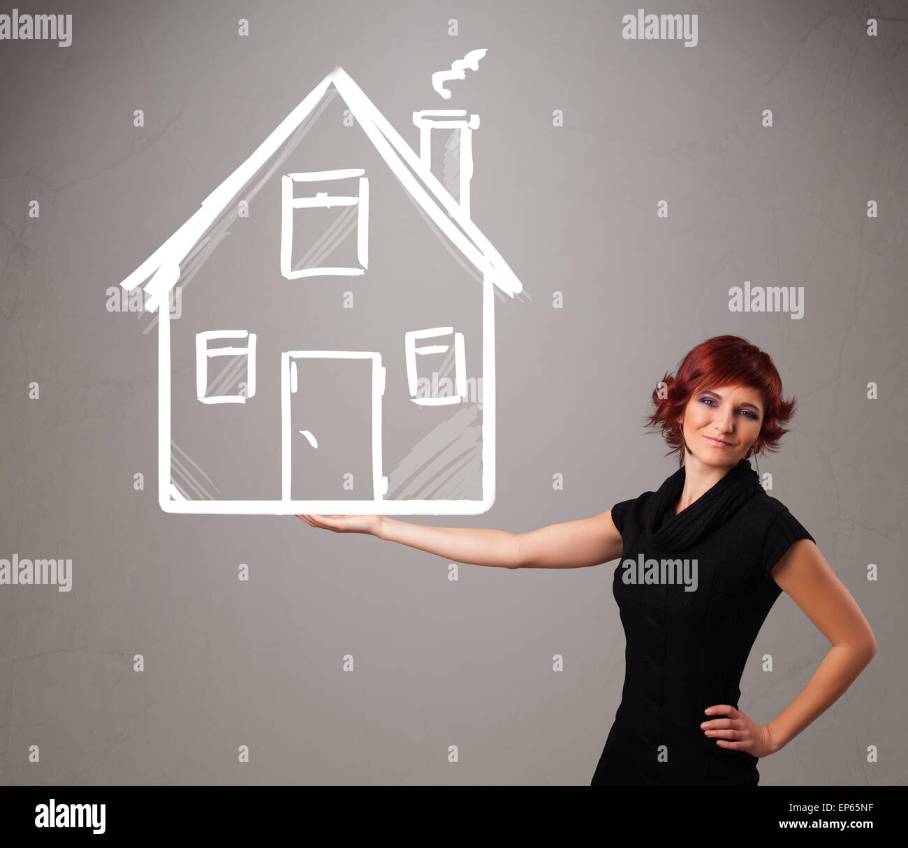 Young lady holding a huge drawn house Stock Photo - Alamy