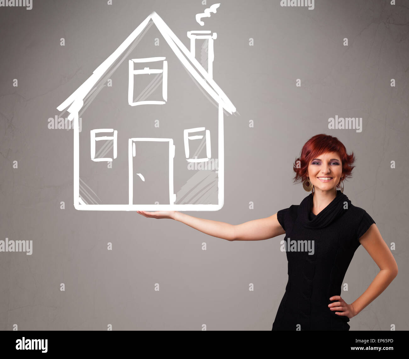 Young lady holding a huge drawn house Stock Photo - Alamy