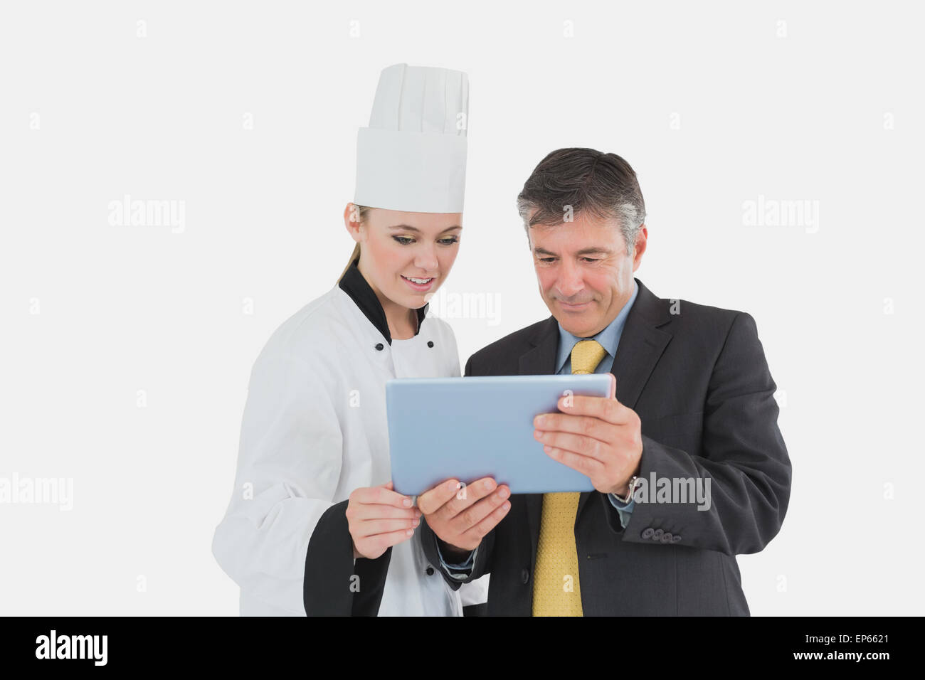Businessman and female chef using digital tablet Stock Photo - Alamy