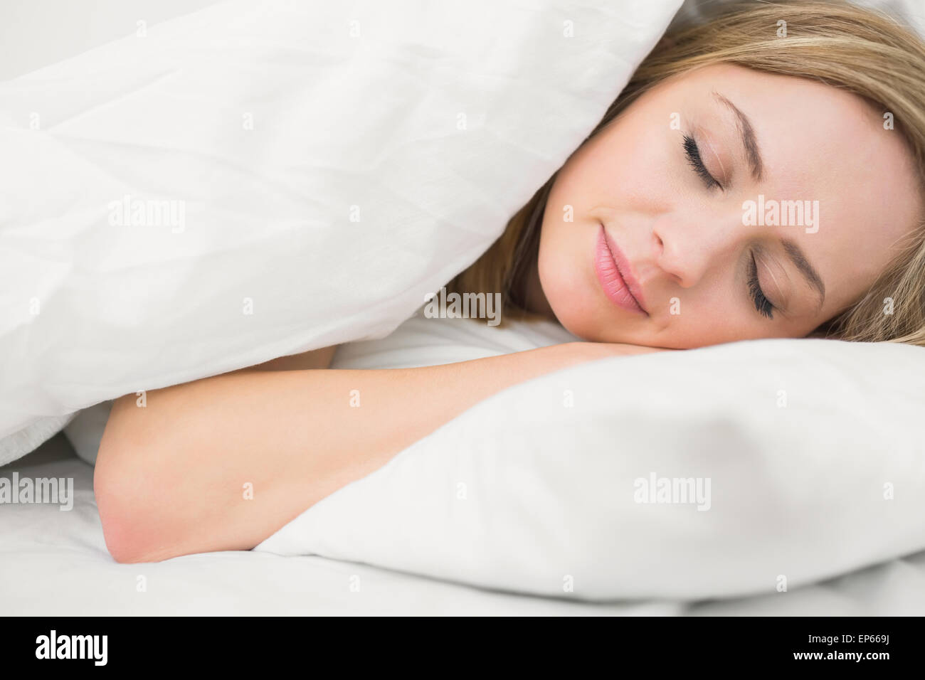 Beautiful woman sleeping with eyes closed in bed Stock Photo - Alamy