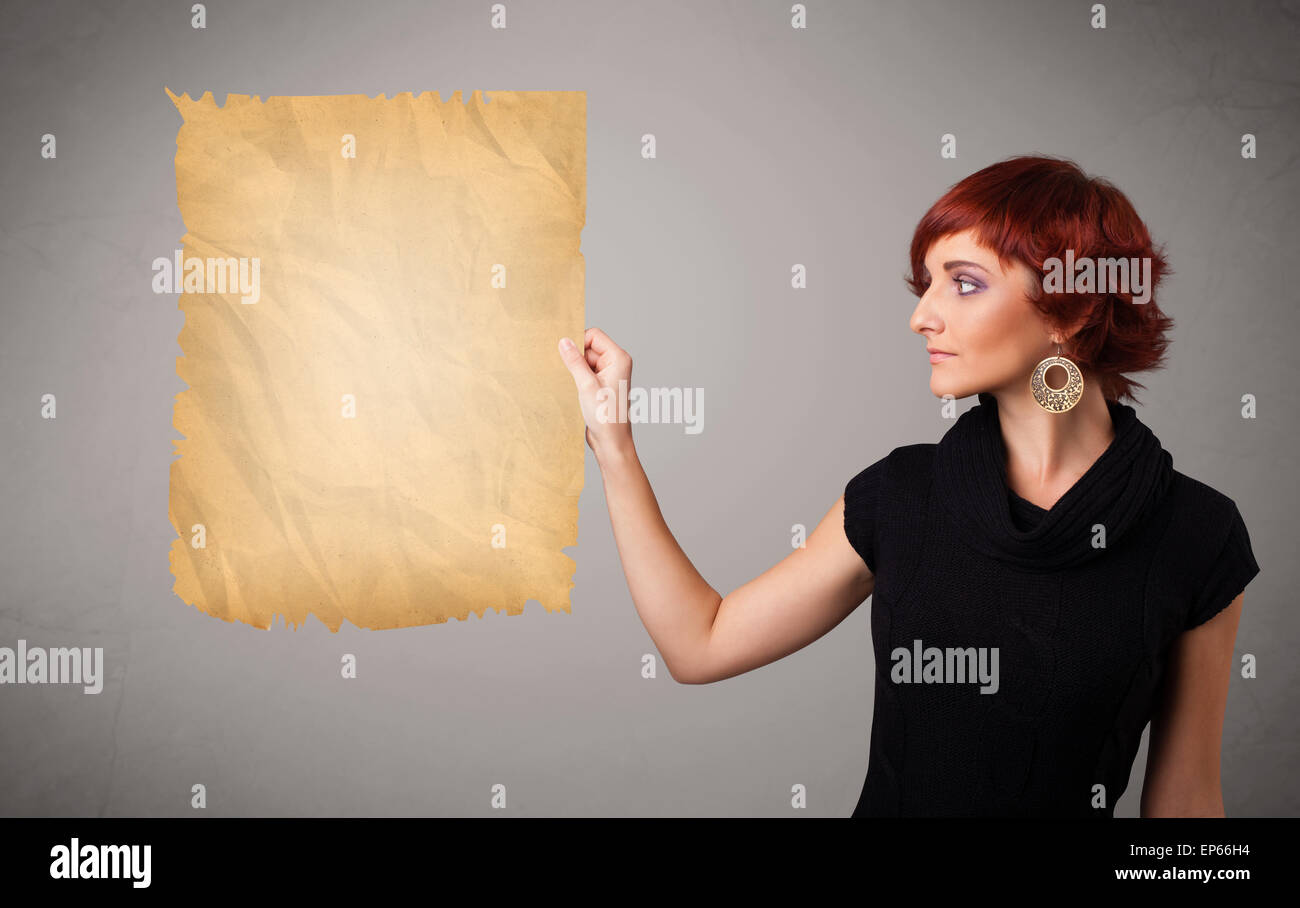Young girl presenting old paper copy space Stock Photo - Alamy