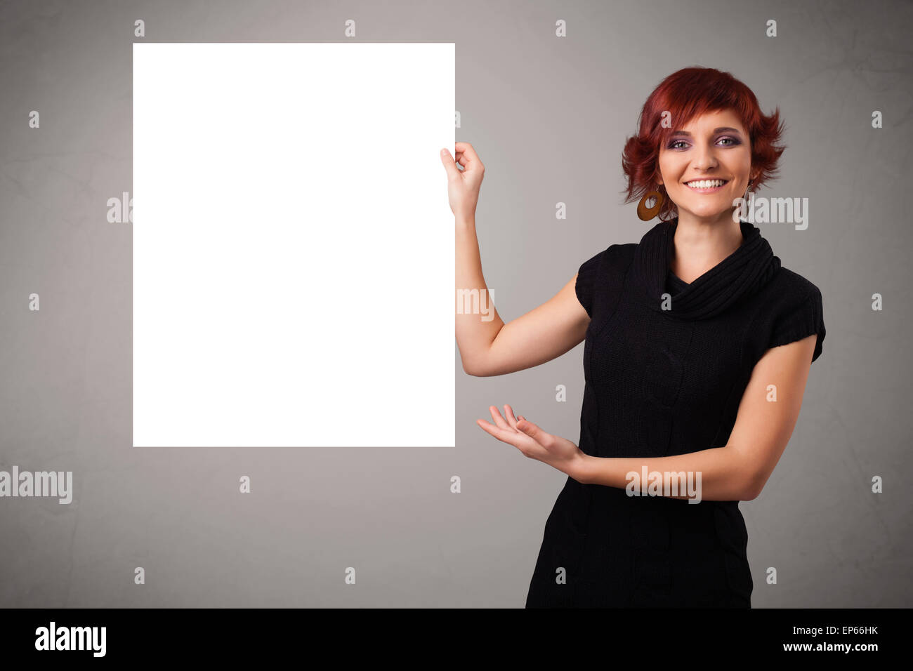 Young woman presenting white paper copy space Stock Photo - Alamy