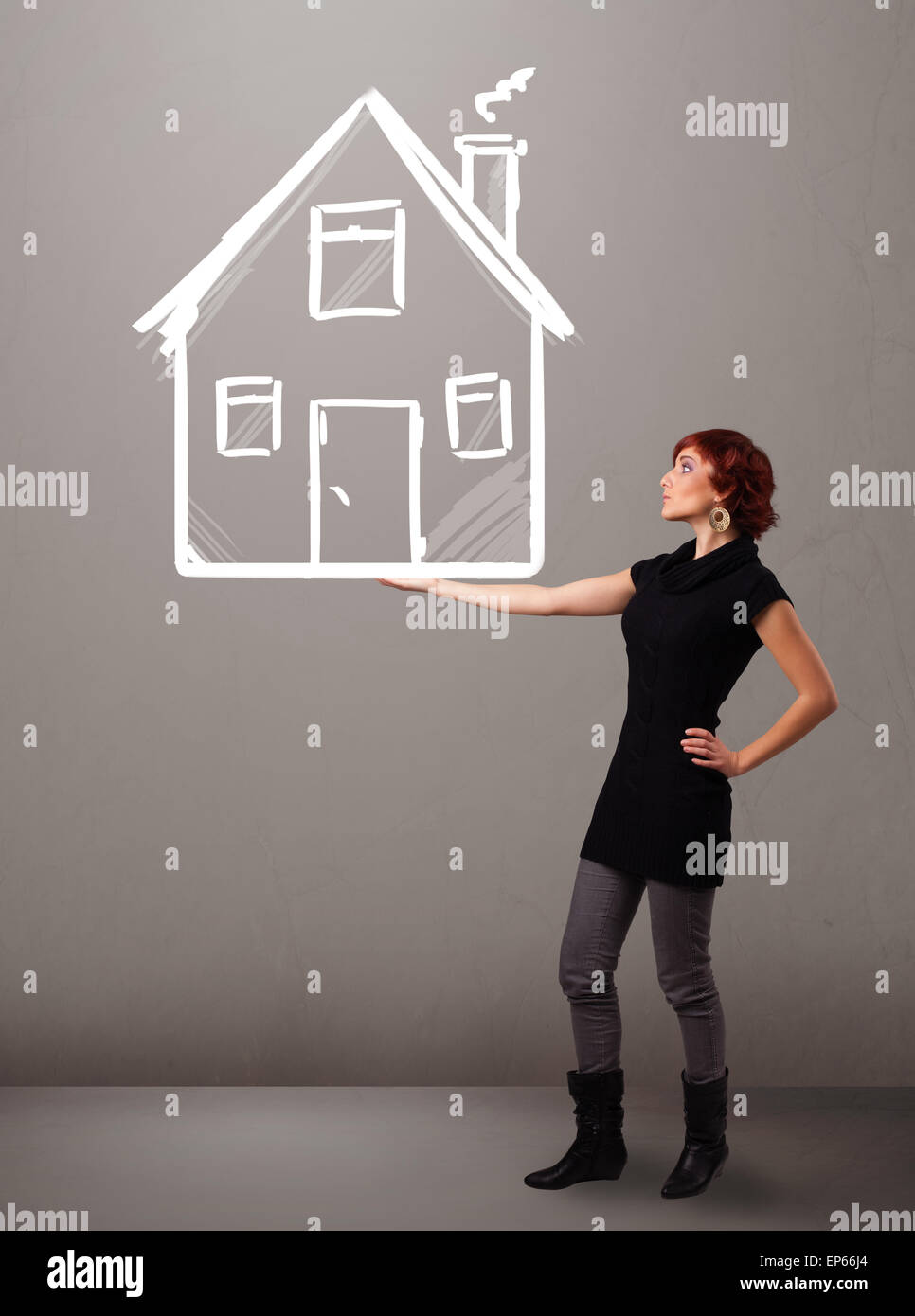 Young lady holding a huge drawn house Stock Photo - Alamy