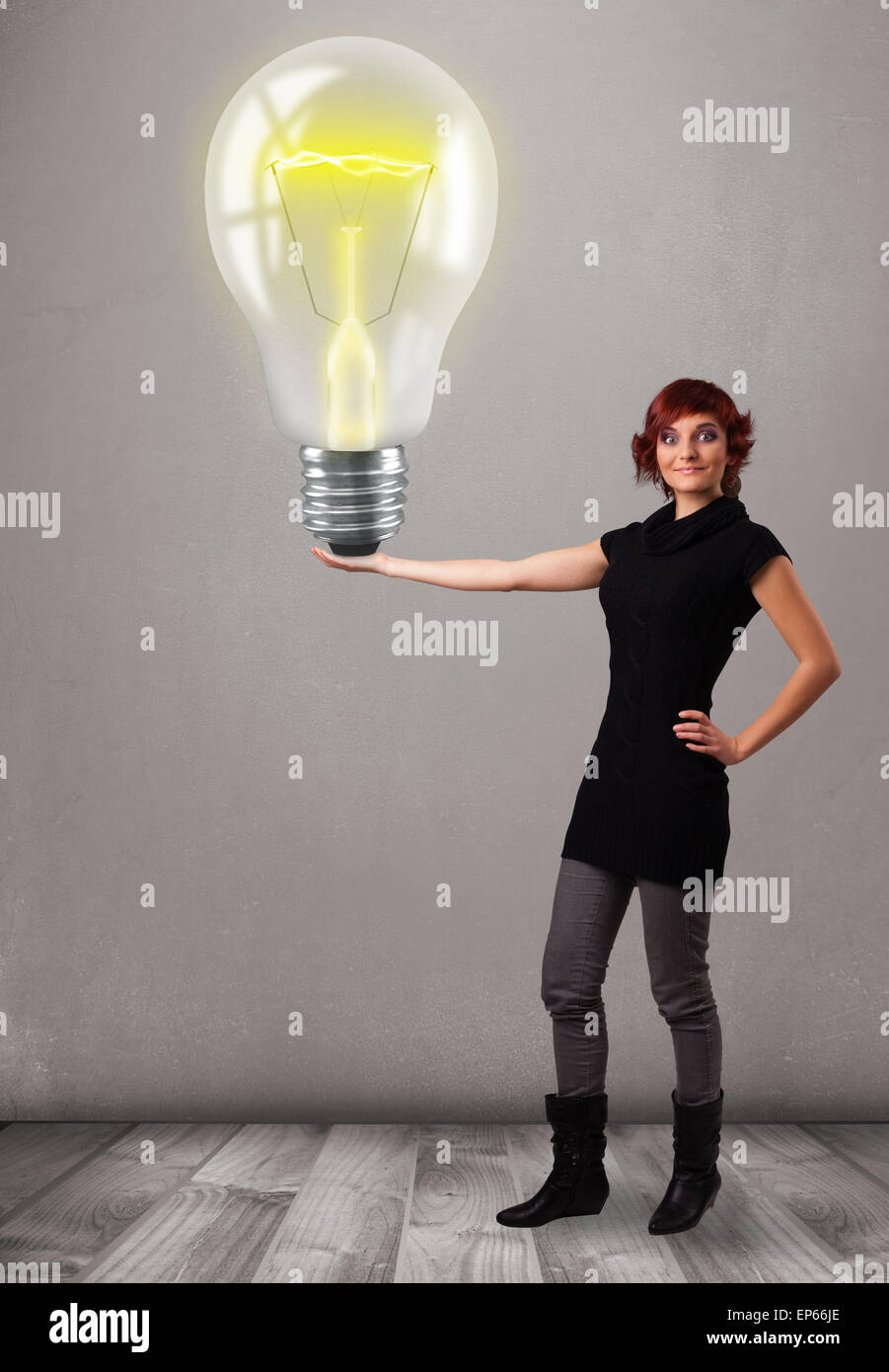 Beautiful lady holding realistic 3d light bulb Stock Photo - Alamy