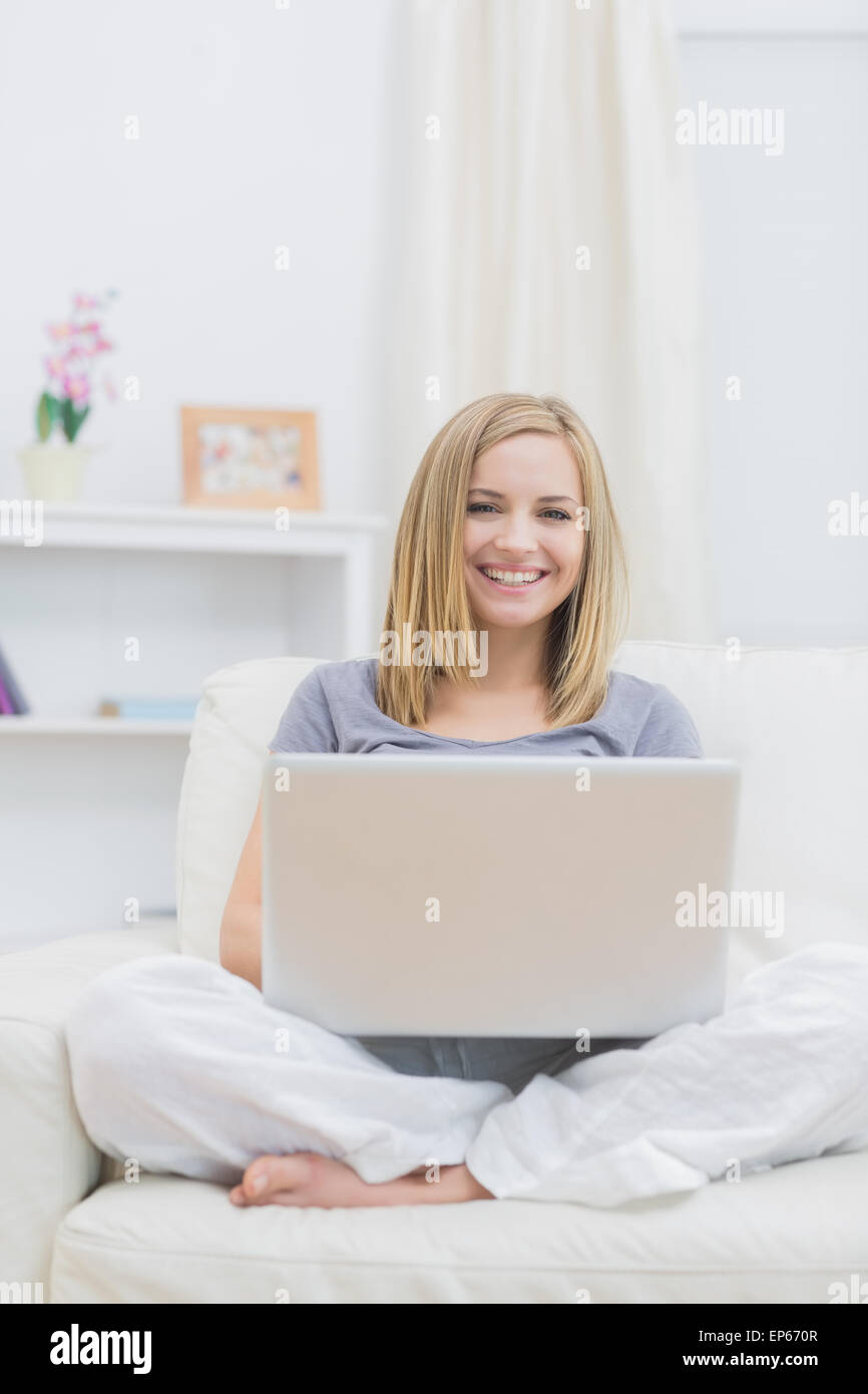 Portrait of relaxed happy woman using laptop on sofa Stock Photo - Alamy