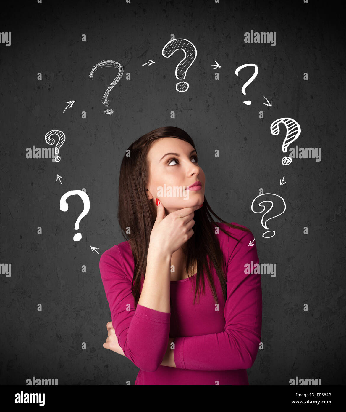 Young woman thinking with question mark circulation around her head ...