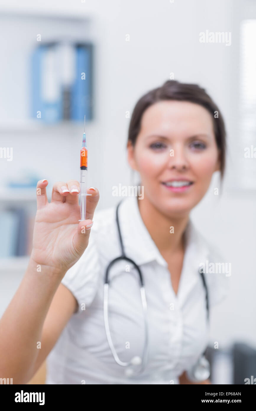 Female doctor holding an injection at hospital Stock Photo - Alamy