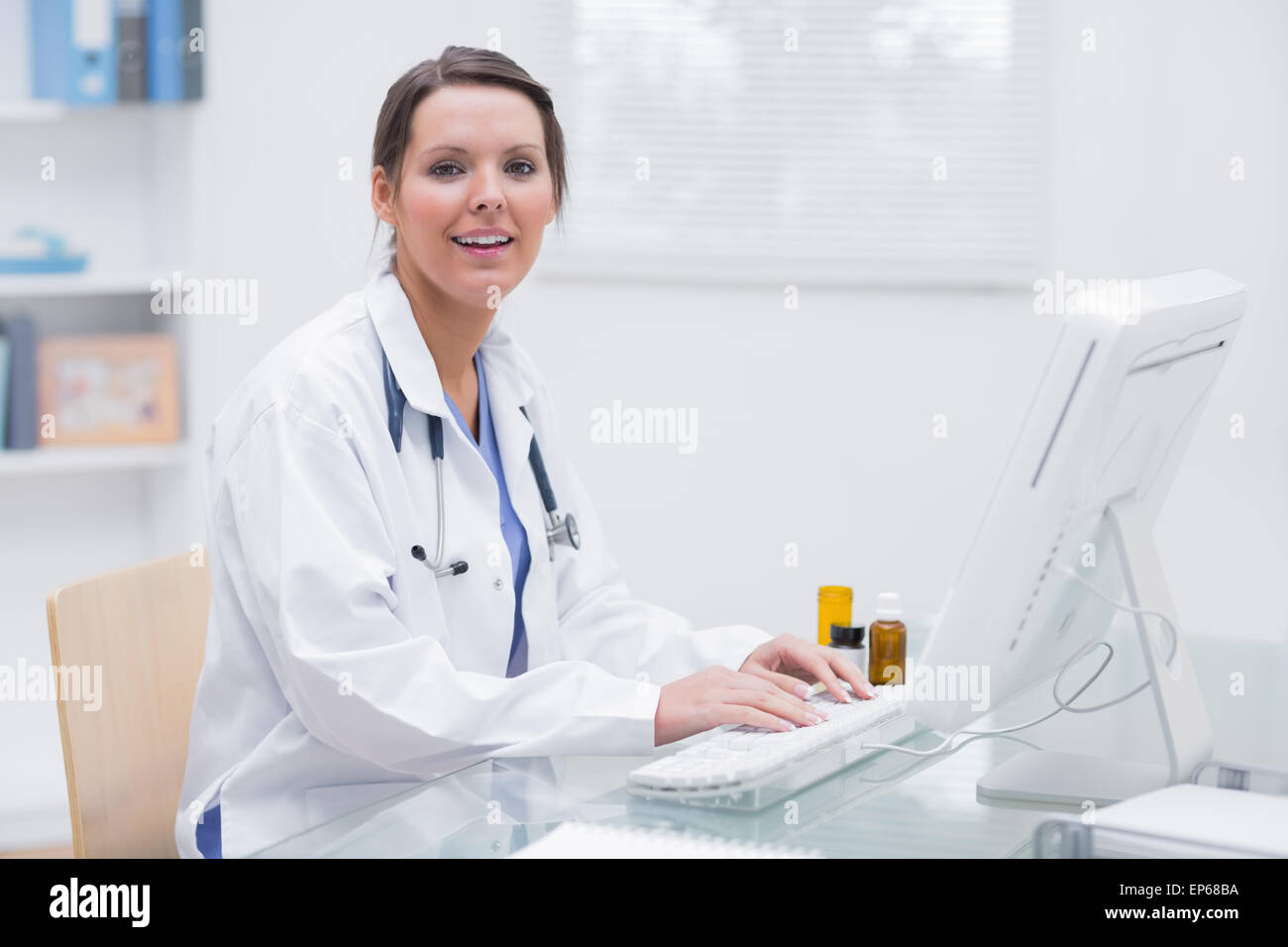 Portrait of female doctor using computer at clinic Stock Photo - Alamy