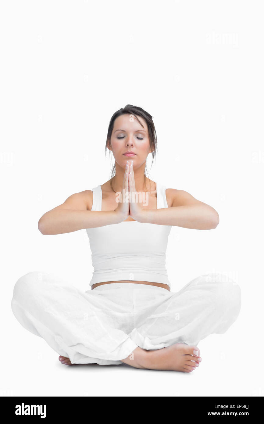 Young woman with crossed legs in praying position Stock Photo - Alamy