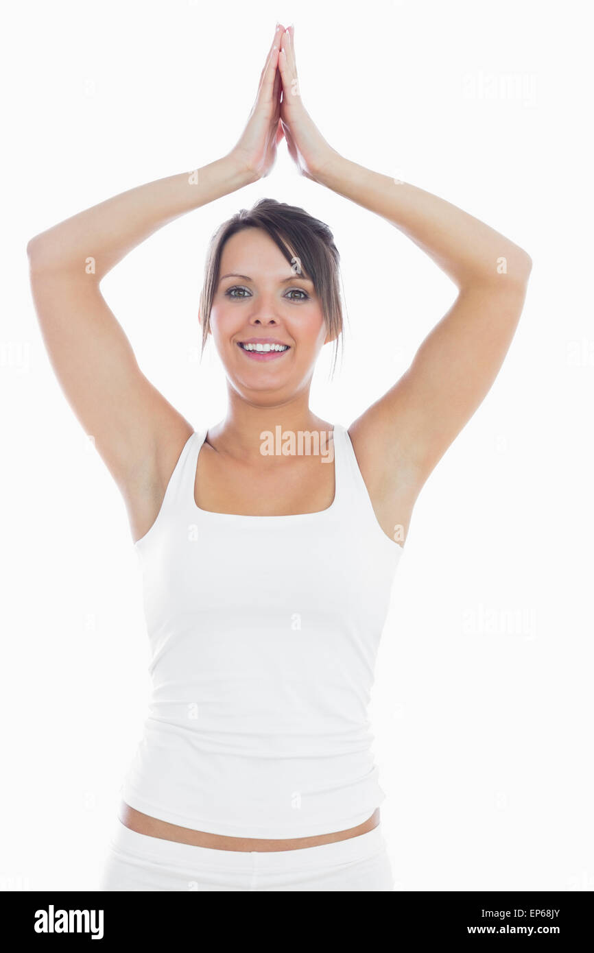 Portrait of woman in sportswear joining hands over head Stock Photo - Alamy