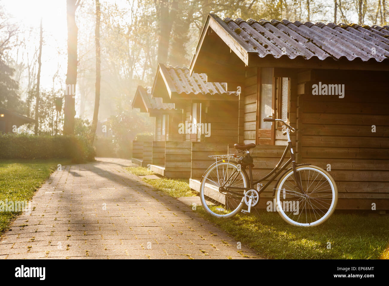 Log cabins and a bicycle Stock Photo - Alamy