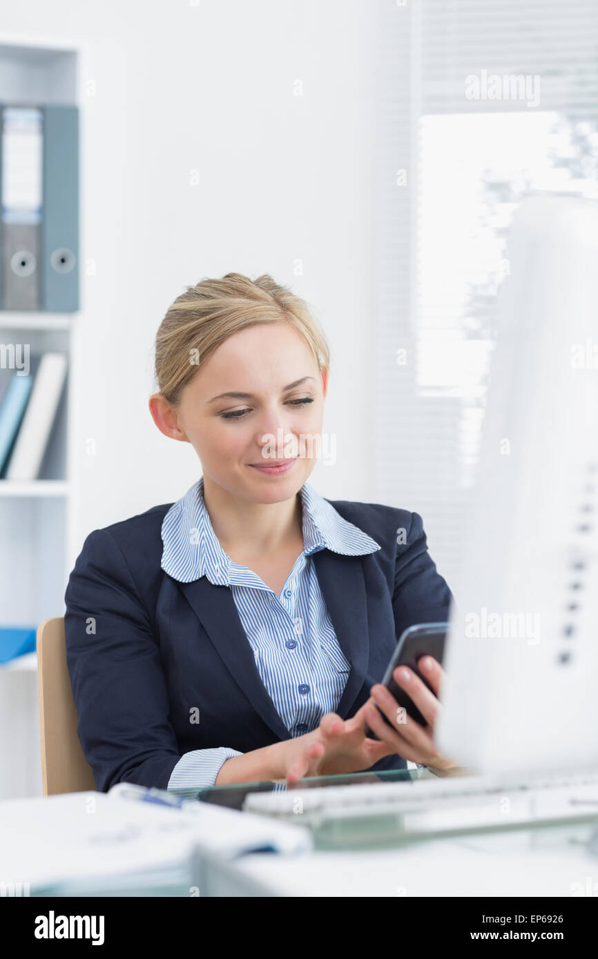 Young business woman text messaging at office desk Stock Photo - Alamy
