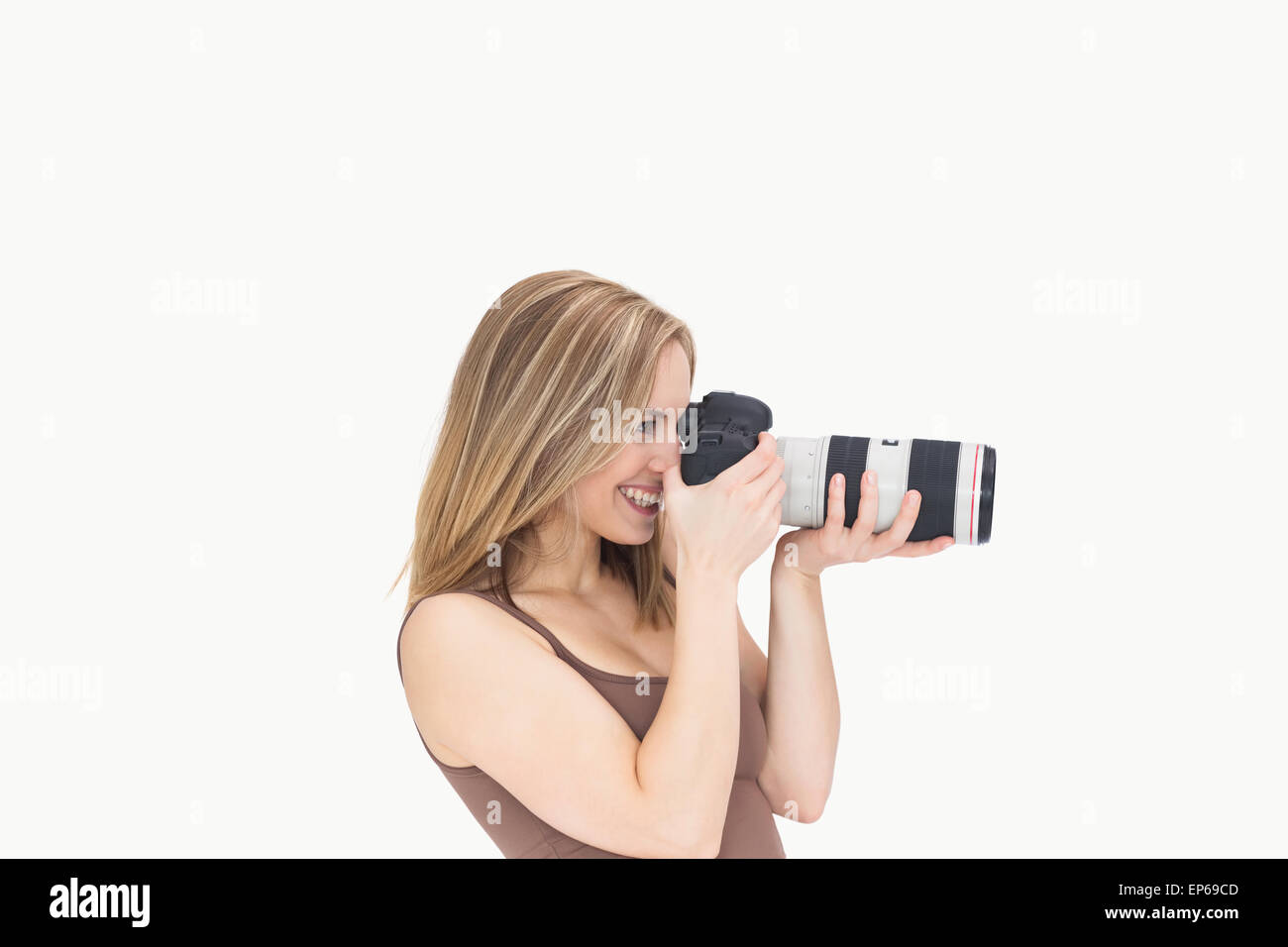 Side view of female photographer with photographic camera Stock Photo ...
