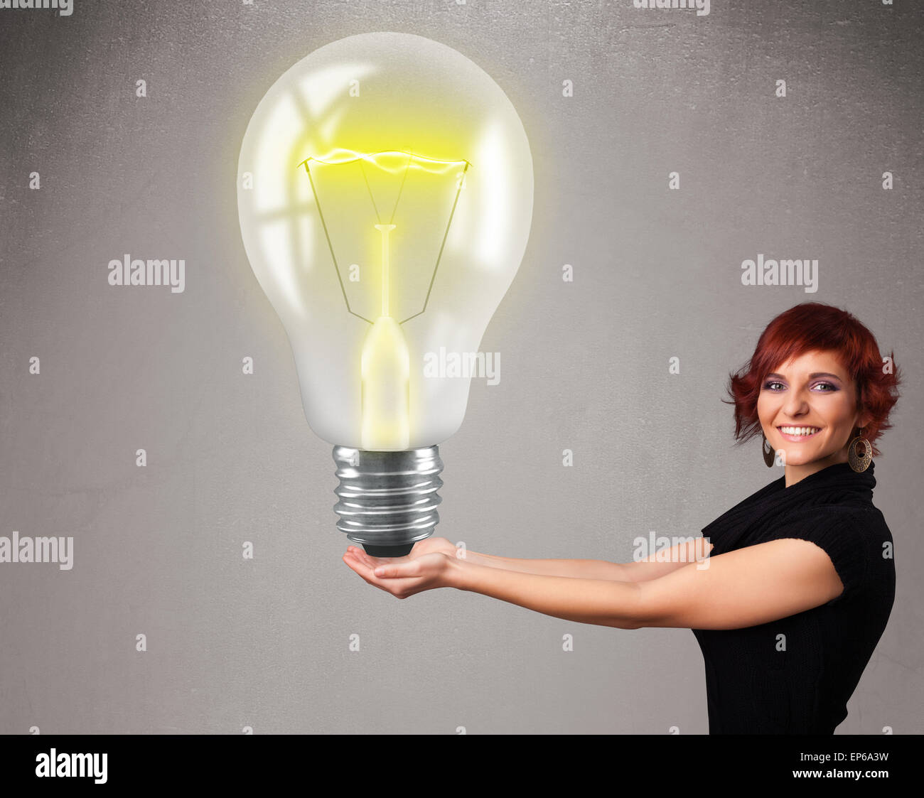 Beautiful lady holding realistic 3d light bulb Stock Photo - Alamy