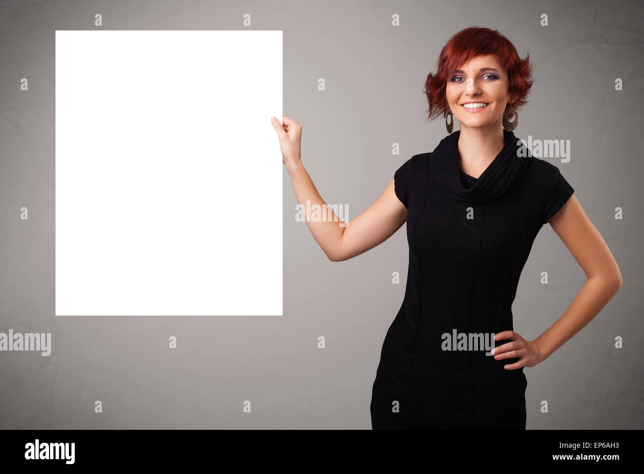Young woman presenting white paper copy space Stock Photo - Alamy