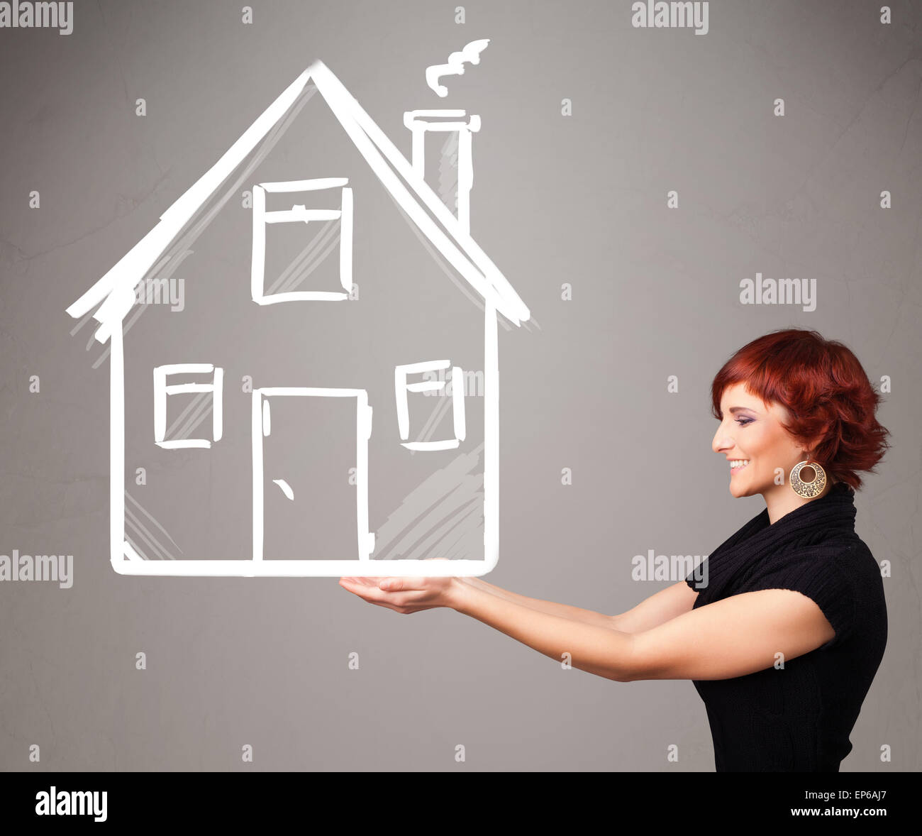 Young lady holding a huge drawn house Stock Photo - Alamy