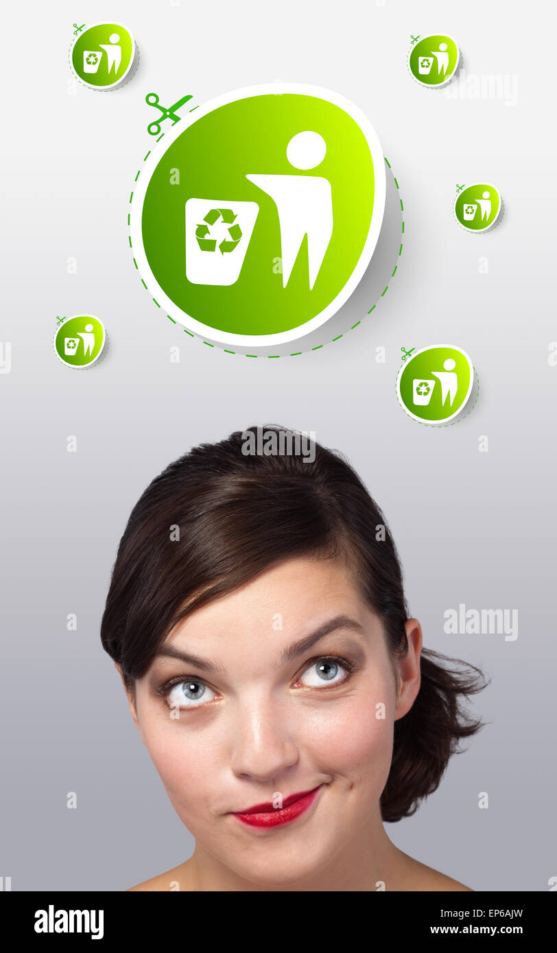 Young girl looking at green eco sign Stock Photo - Alamy