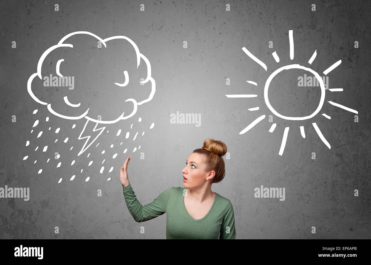 Woman standing between a sun and a rain drawing Stock Photo - Alamy