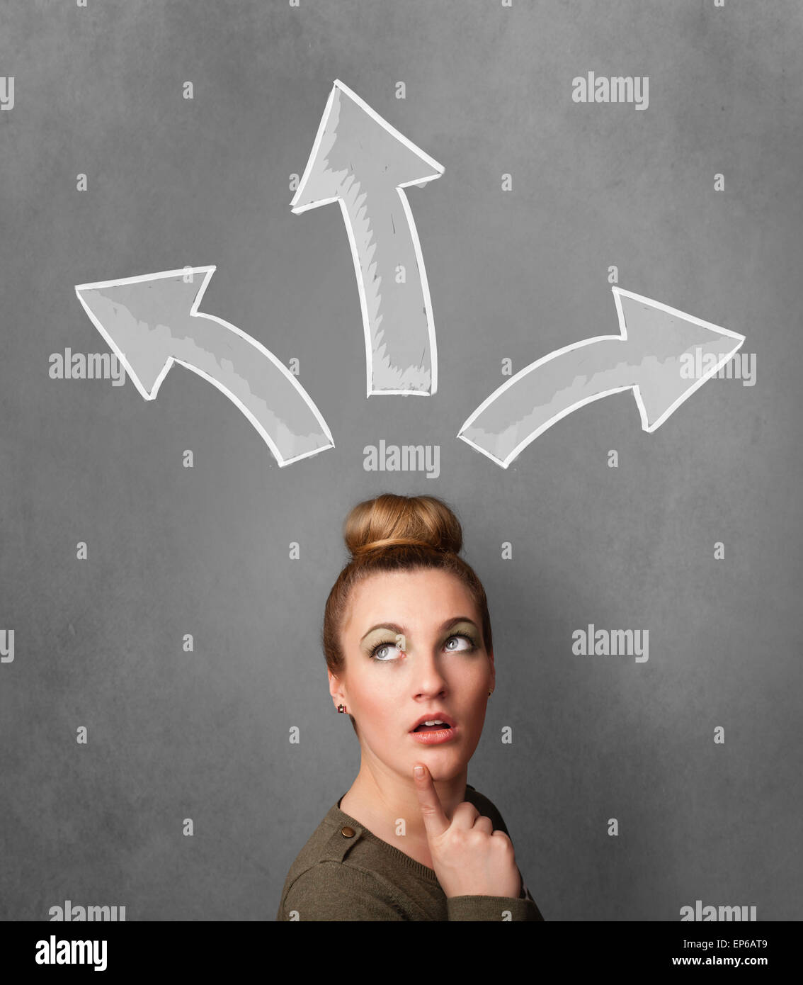 Young woman thinking with arrows above her head Stock Photo - Alamy