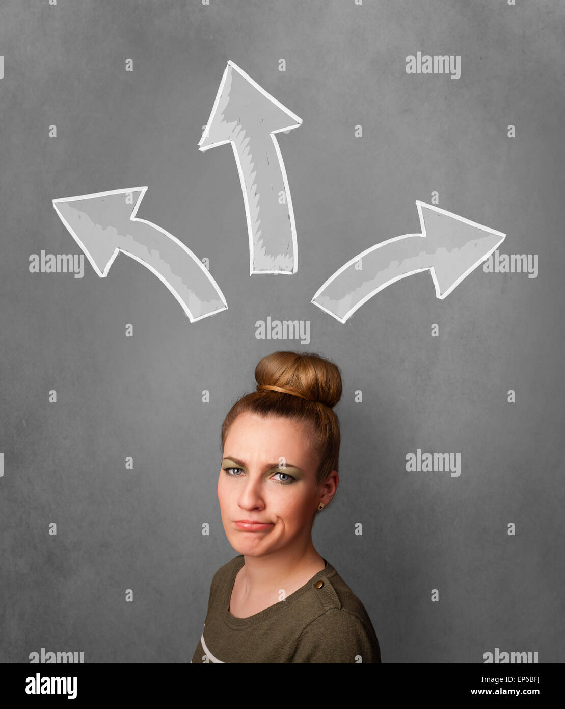 Young woman thinking with arrows above her head Stock Photo - Alamy