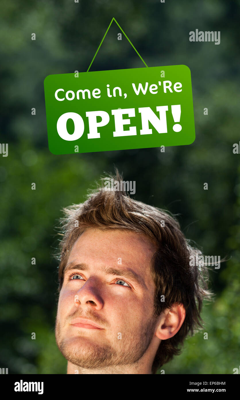 Young persons head looking at closed and open signs Stock Photo - Alamy
