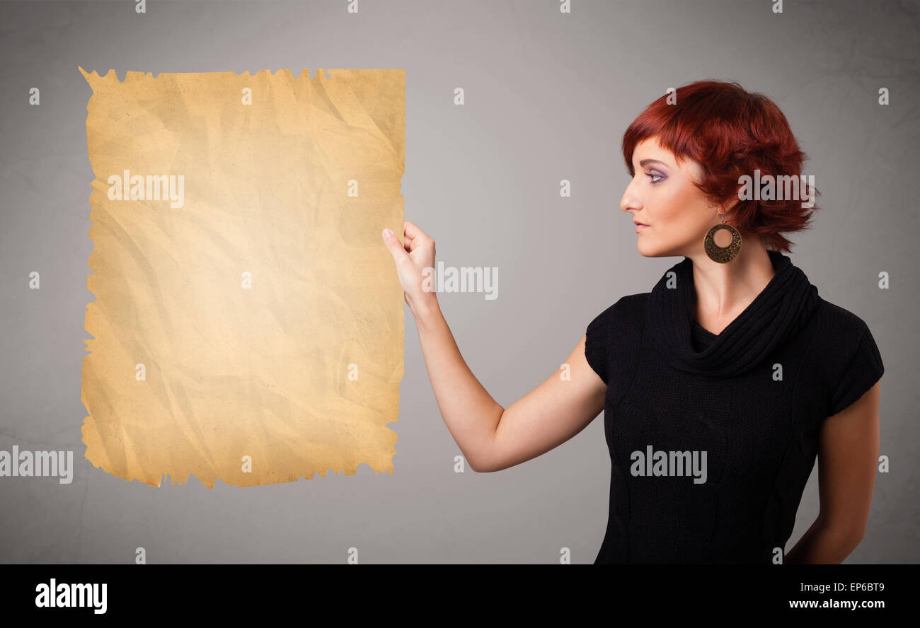 Young girl presenting old paper copy space Stock Photo - Alamy