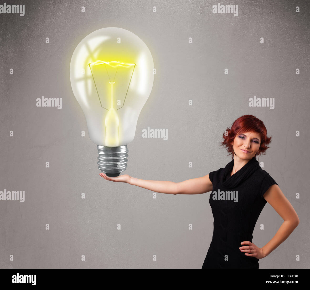 Beautiful lady holding realistic 3d light bulb Stock Photo - Alamy
