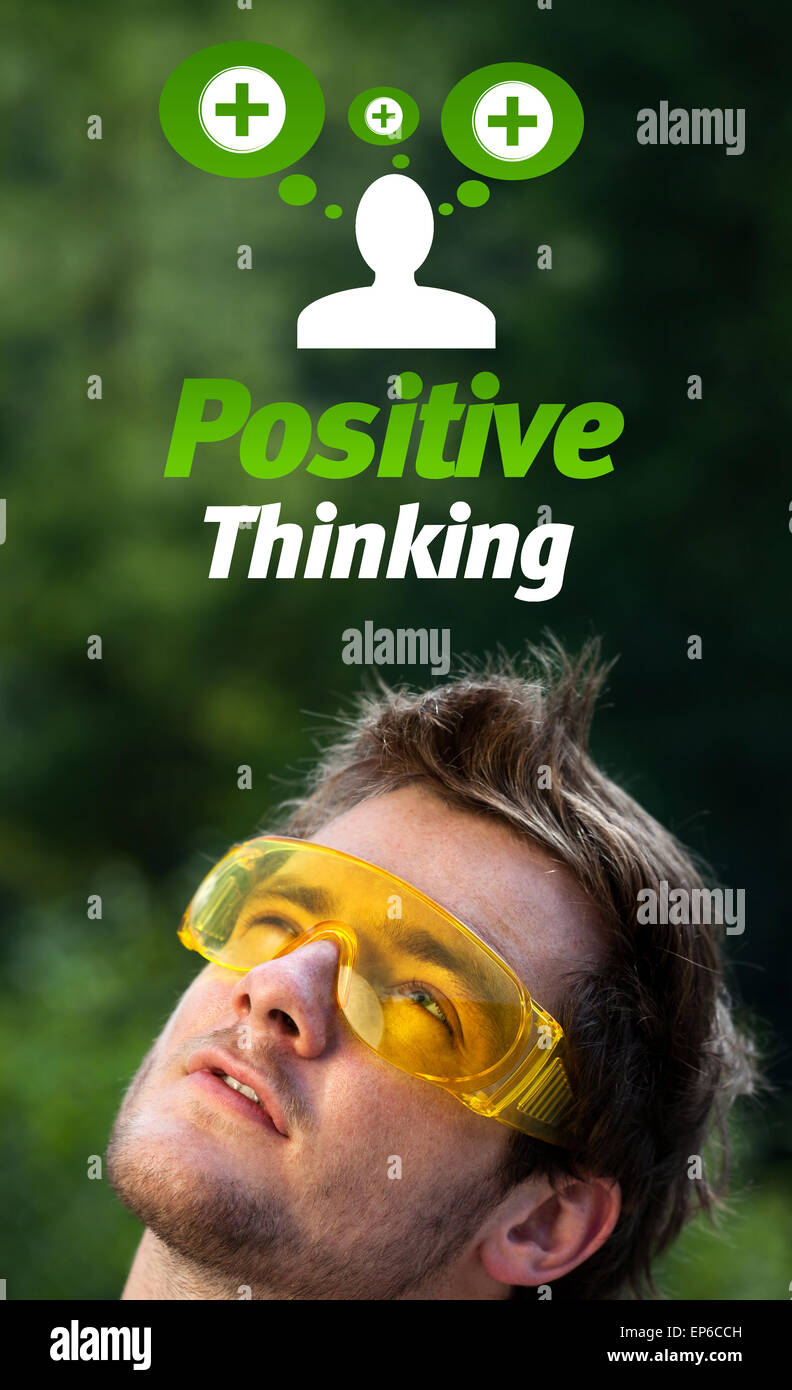 Young head looking at positive negative signs Stock Photo - Alamy