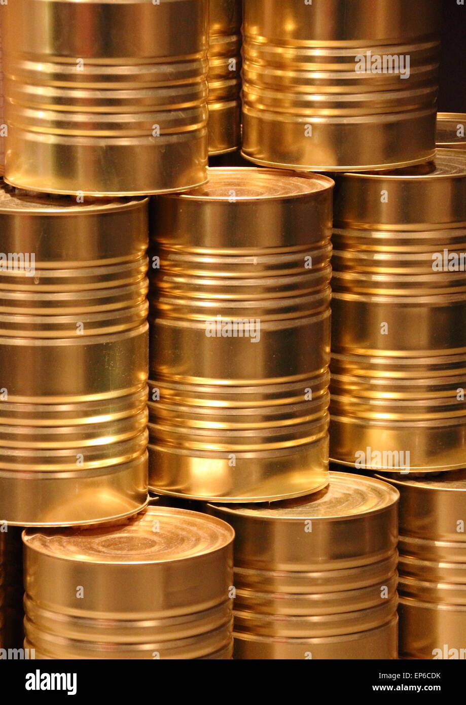 Vertical stack of golden metal food can background Stock Photo - Alamy