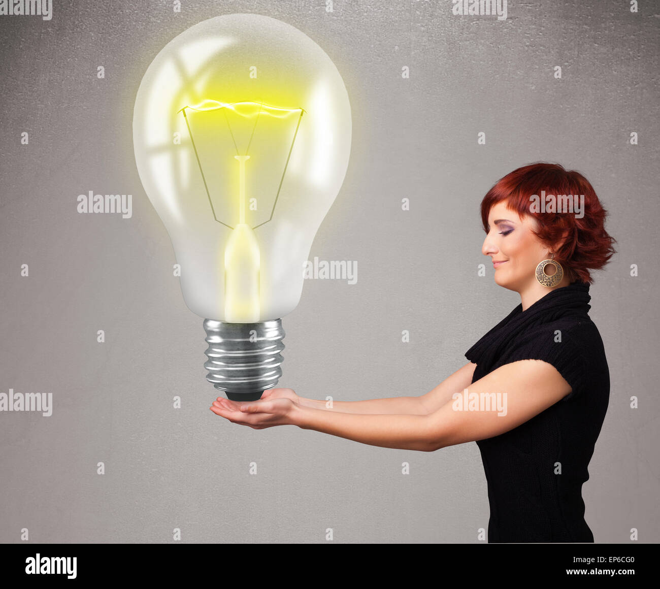 Beautiful lady holding realistic 3d light bulb Stock Photo - Alamy