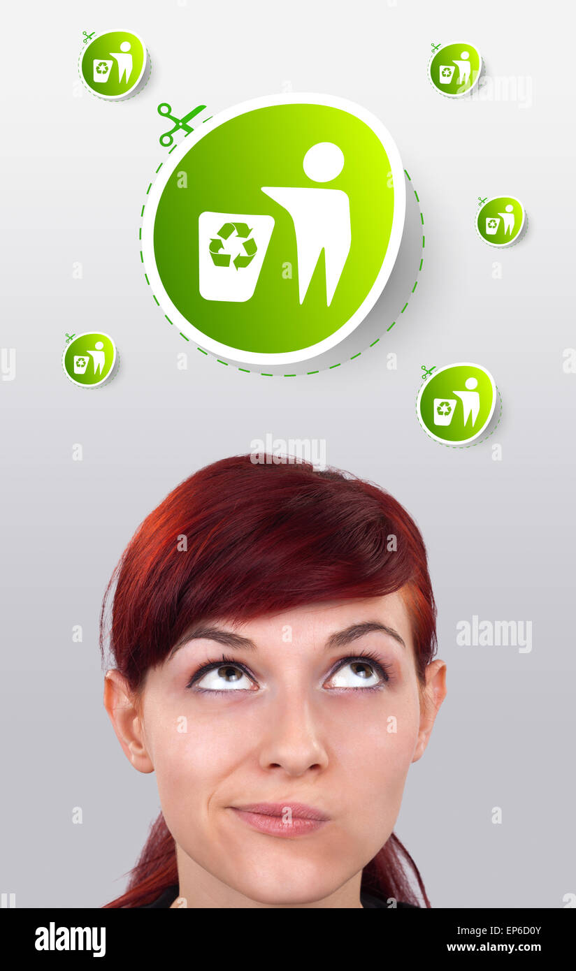 Young girl looking at green eco sign Stock Photo - Alamy