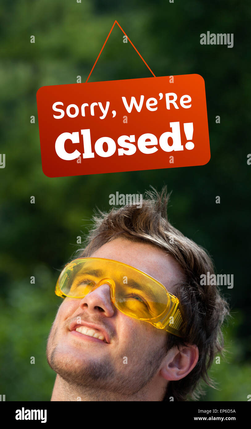 Young persons head looking at closed and open signs Stock Photo - Alamy