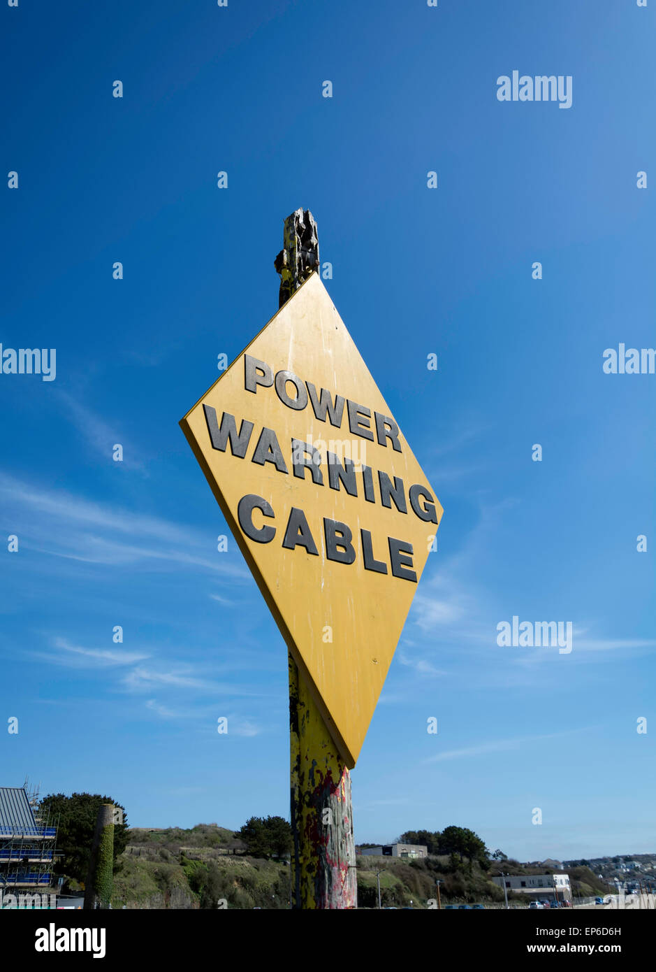 Yellow power warning sign against a clear blue sky Stock Photo - Alamy