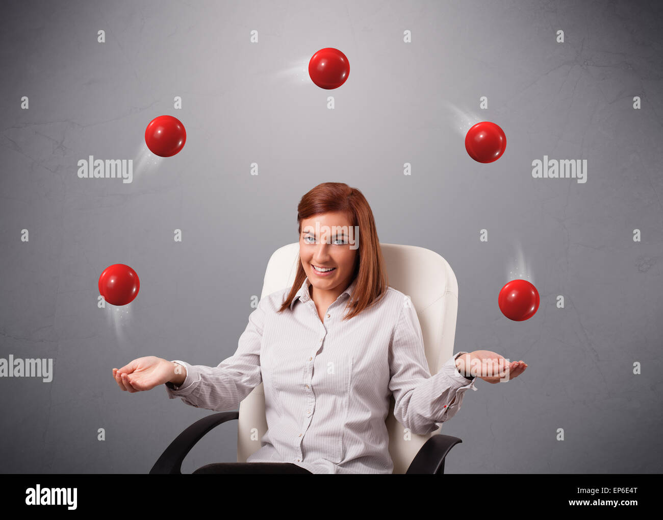 young girl sitting and juggling with red balls Stock Photo - Alamy