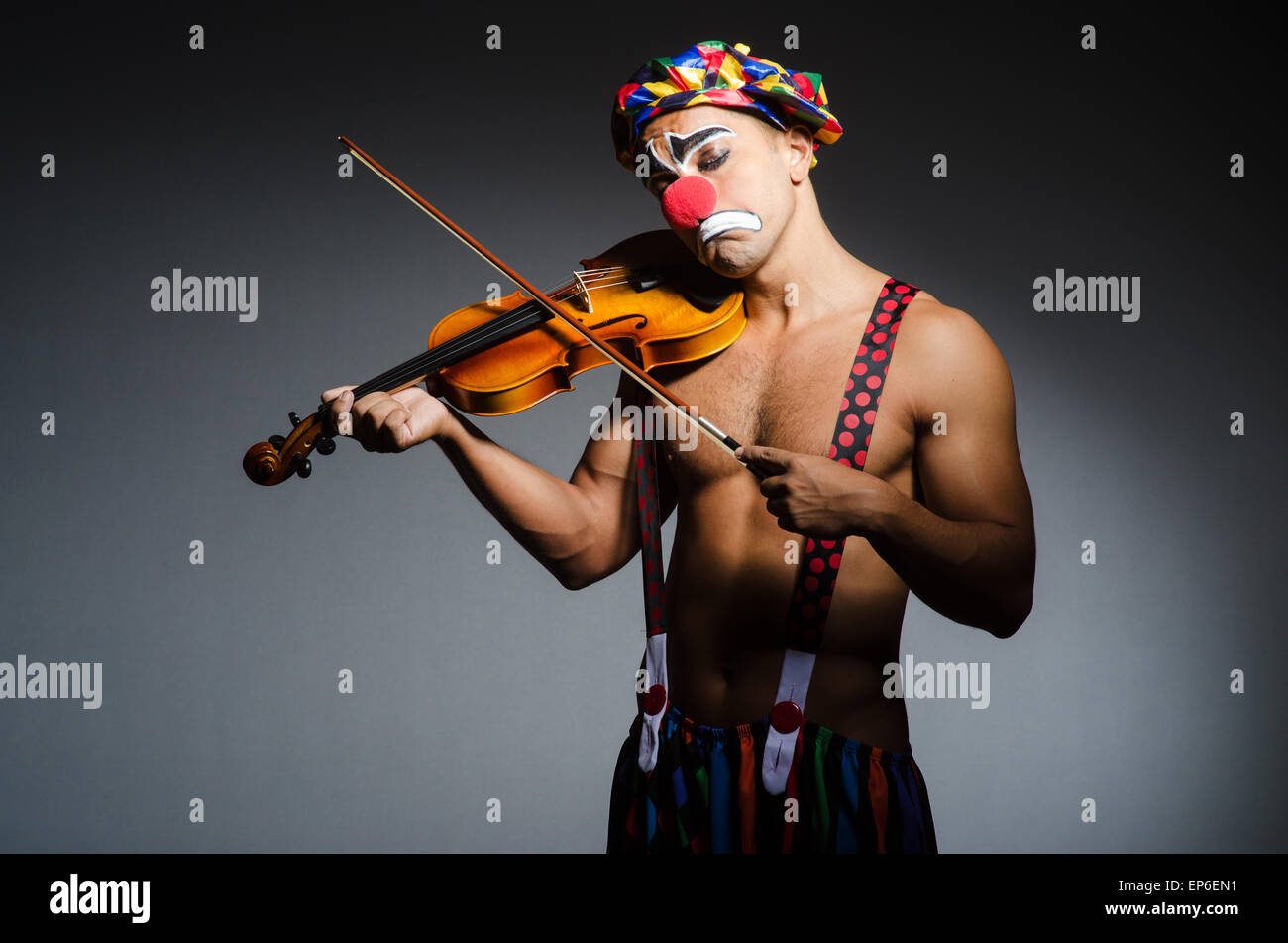 Sad clown performing at vioin Stock Photo - Alamy