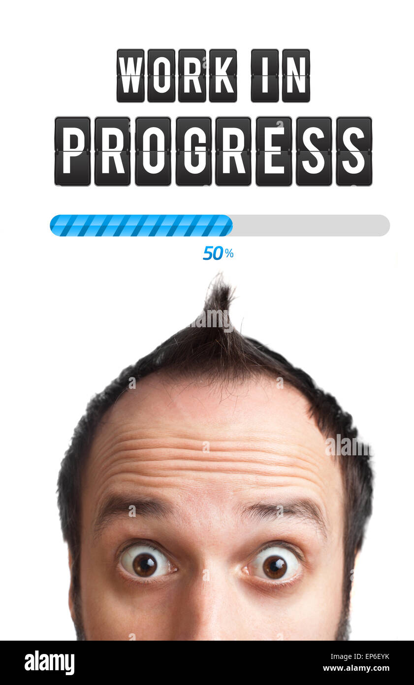 Young man with Work in progress sign over his head Stock Photo - Alamy