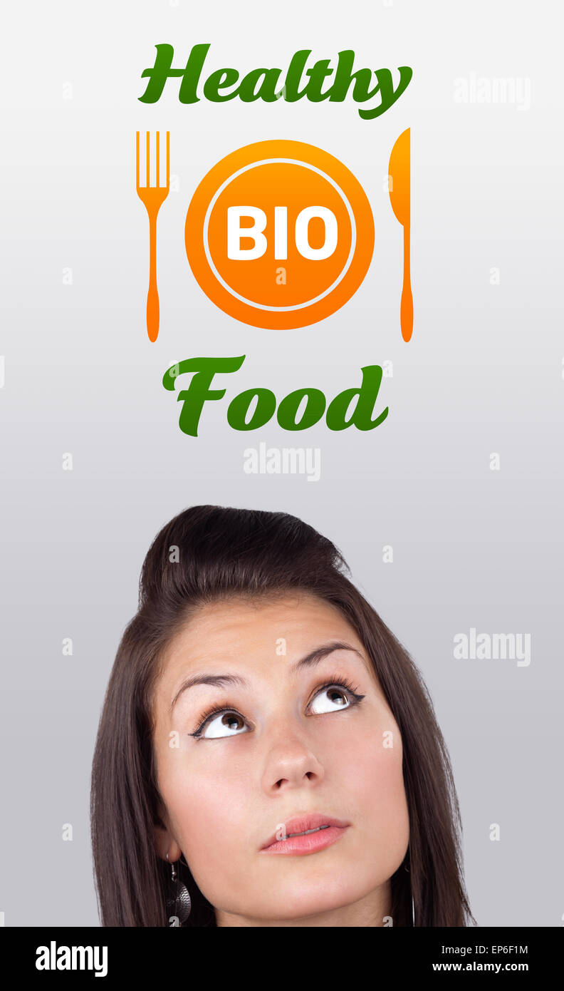 Young girl looking at healthy food sign Stock Photo - Alamy