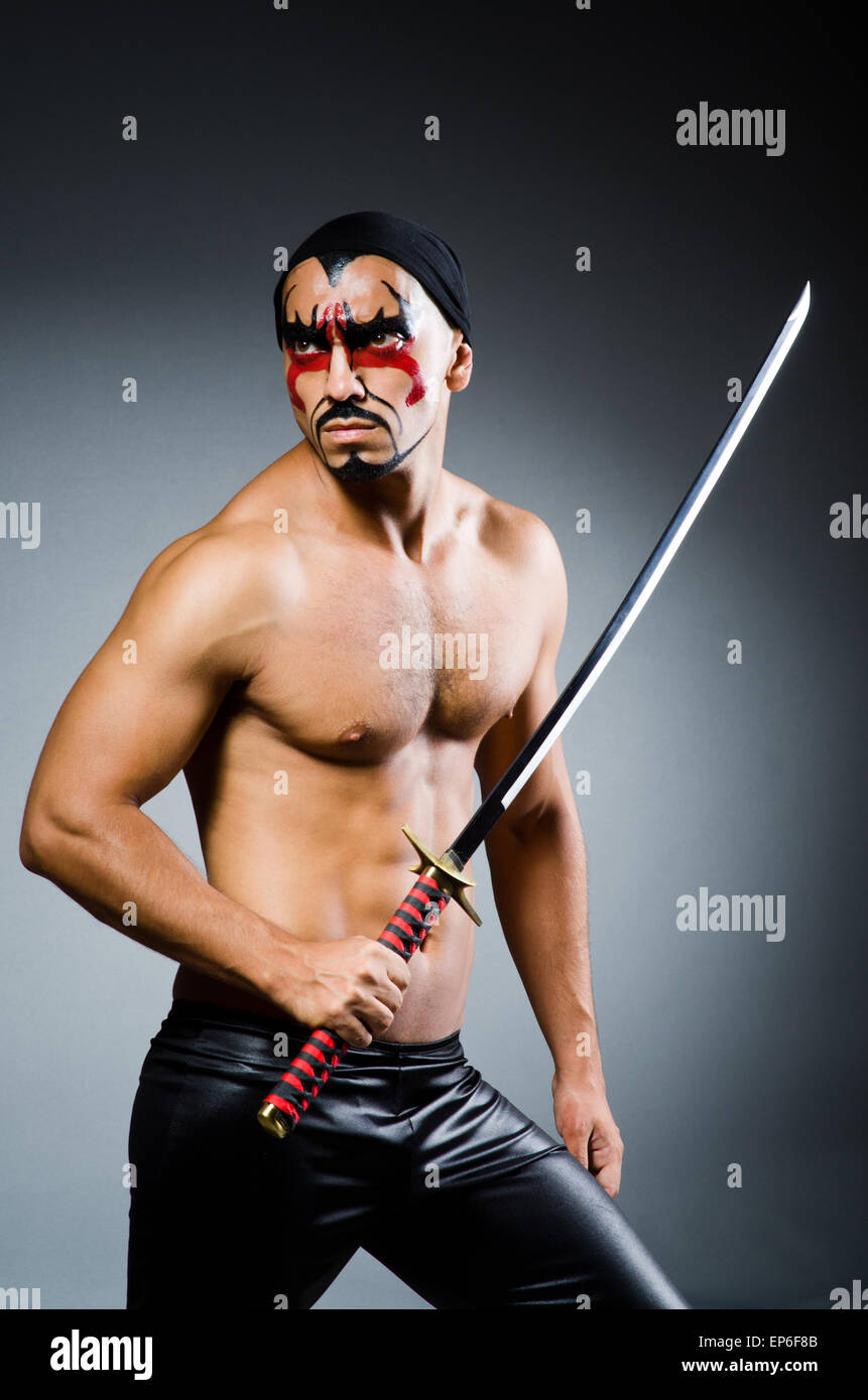 Man with sword and face paint Stock Photo - Alamy