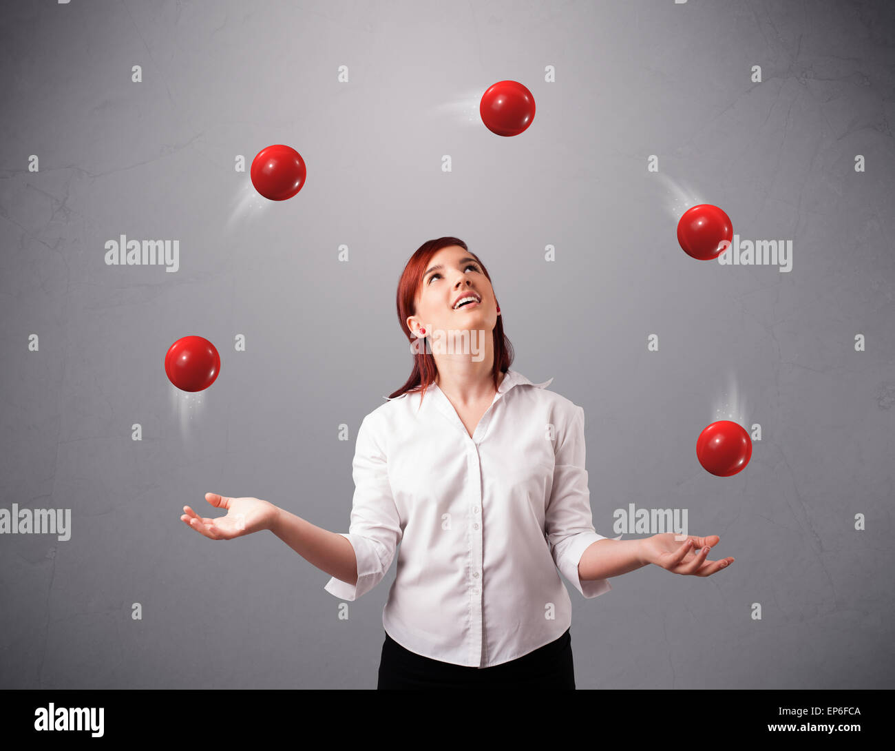 young girl standing and juggling with red balls Stock Photo - Alamy