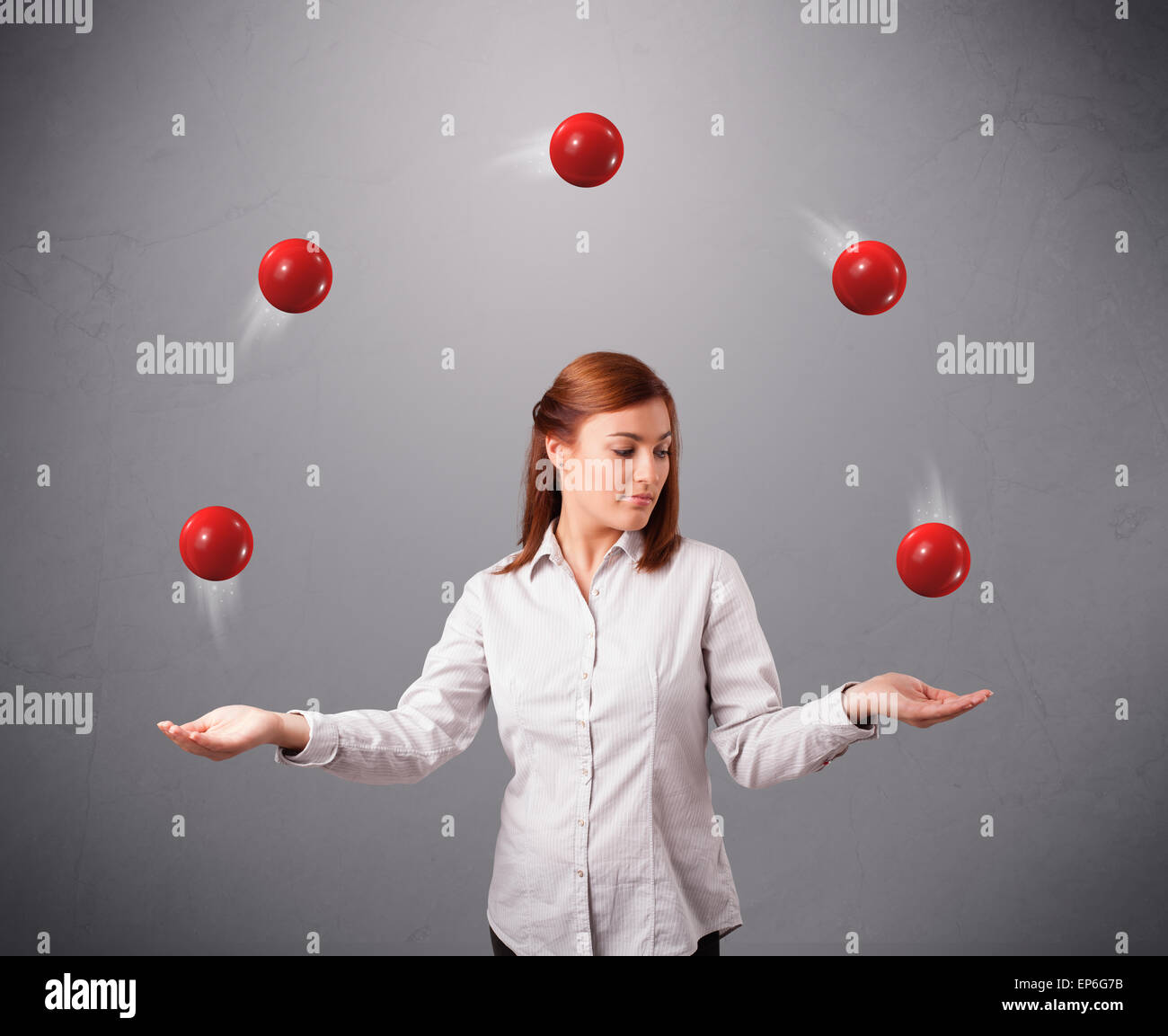 young girl standing and juggling with red balls Stock Photo - Alamy