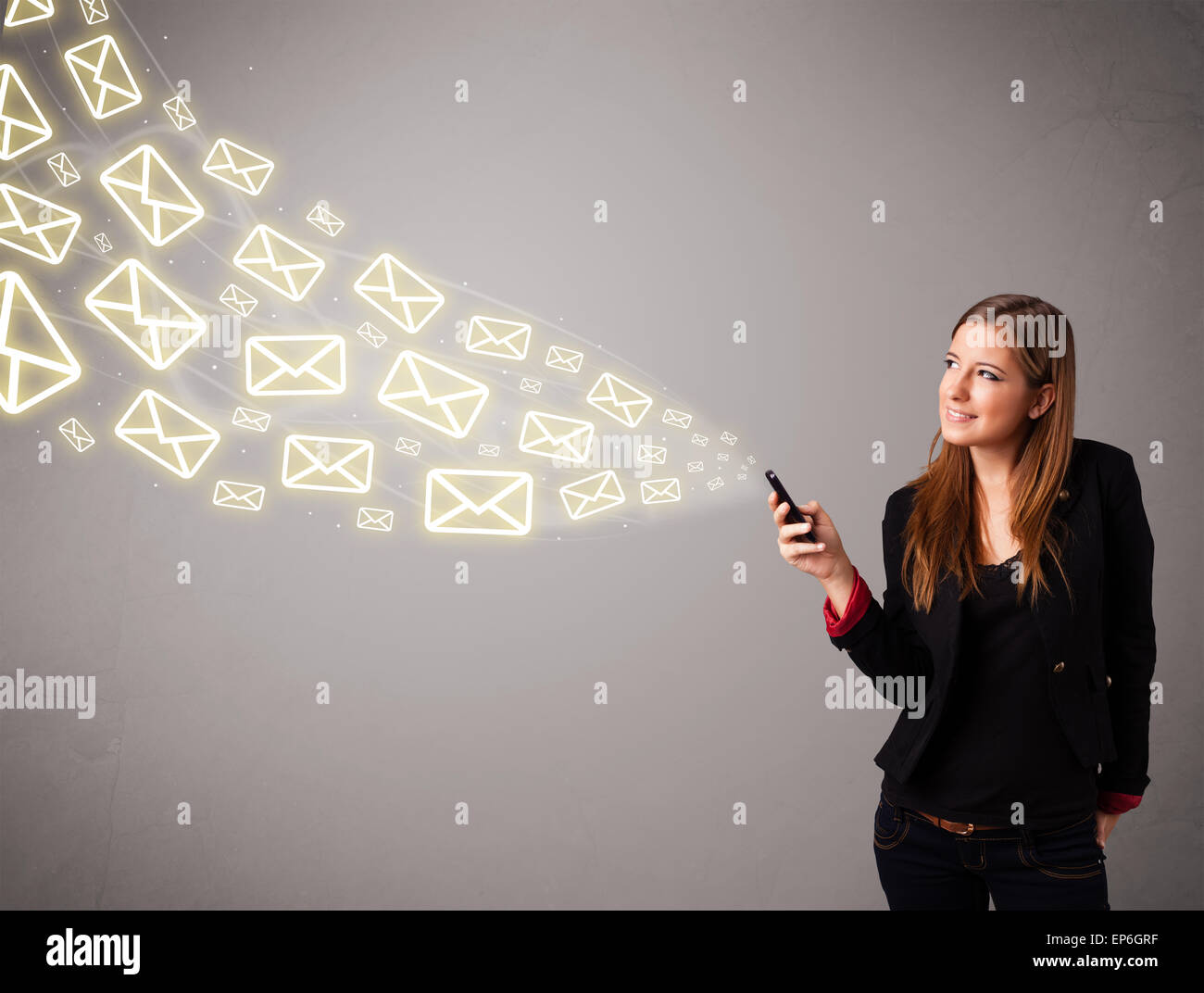 attractive young lady holding a phone with message icons Stock Photo ...