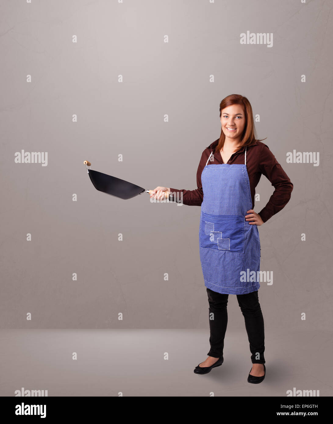 Young lady holding a frying pan Stock Photo - Alamy