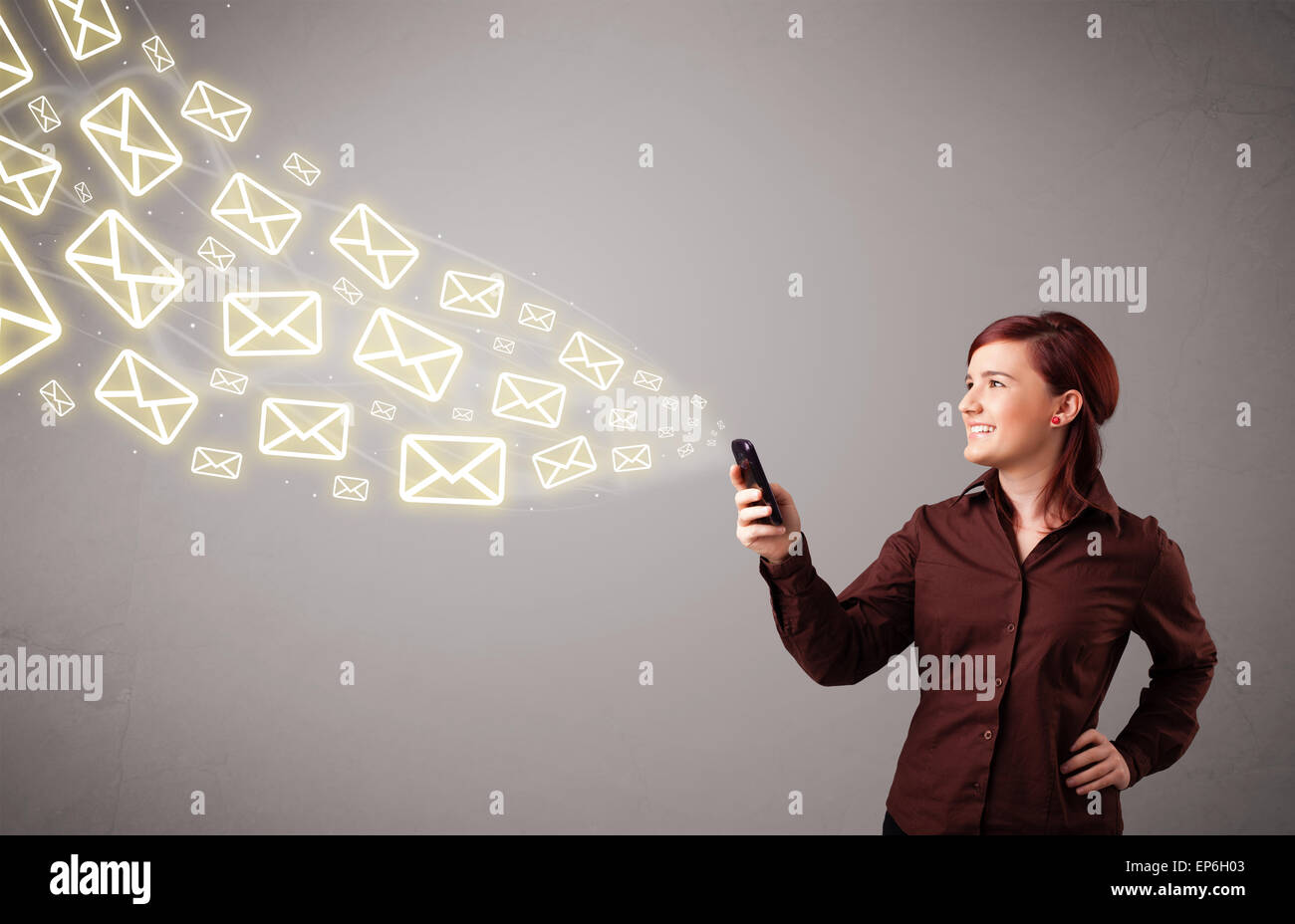 attractive young lady holding a phone with message icons Stock Photo ...