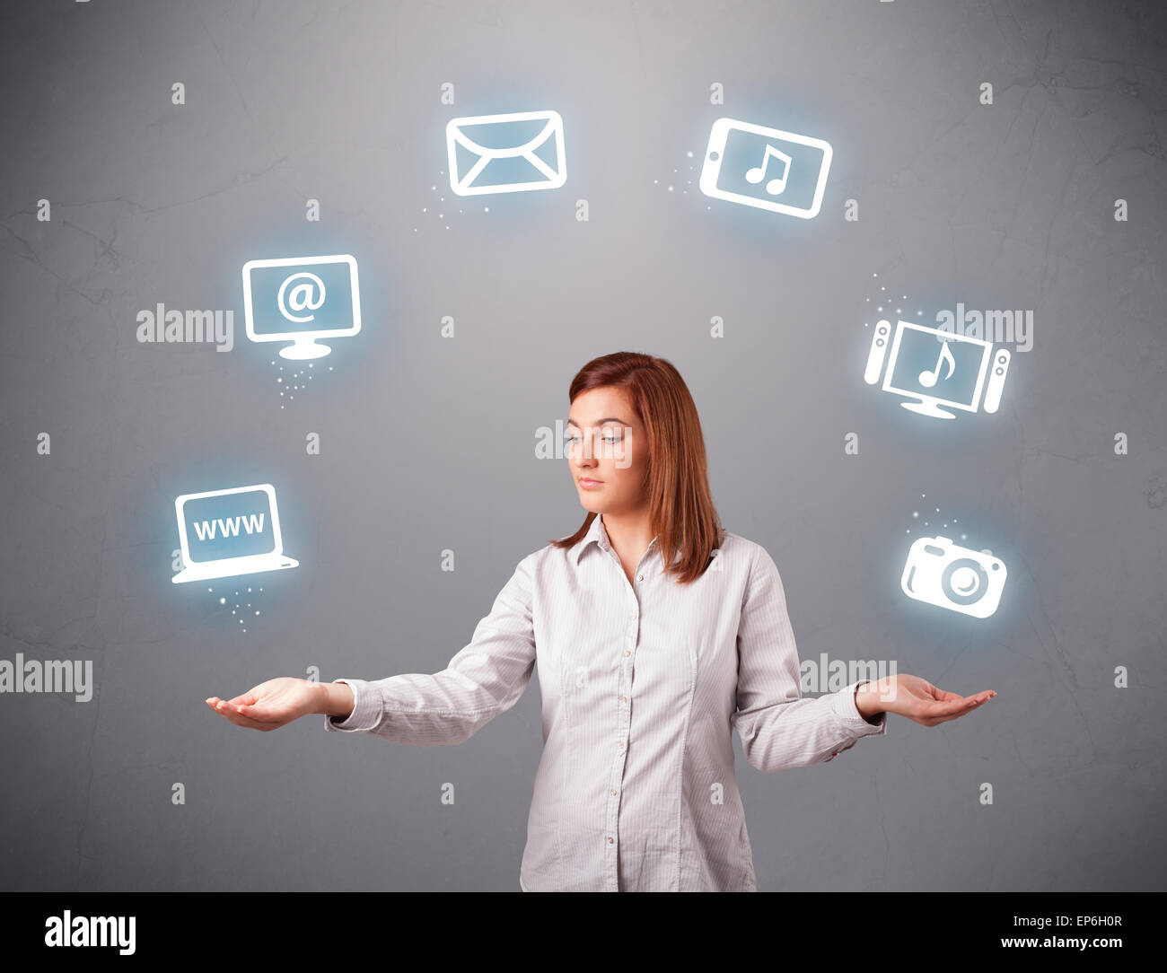 pretty girl juggling with elecrtonic devices icons Stock Photo - Alamy