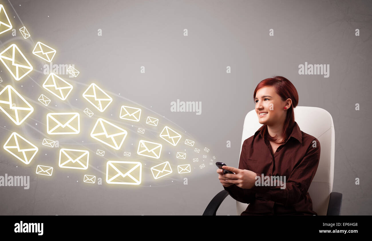 attractive young lady holding a phone with message icons Stock Photo ...