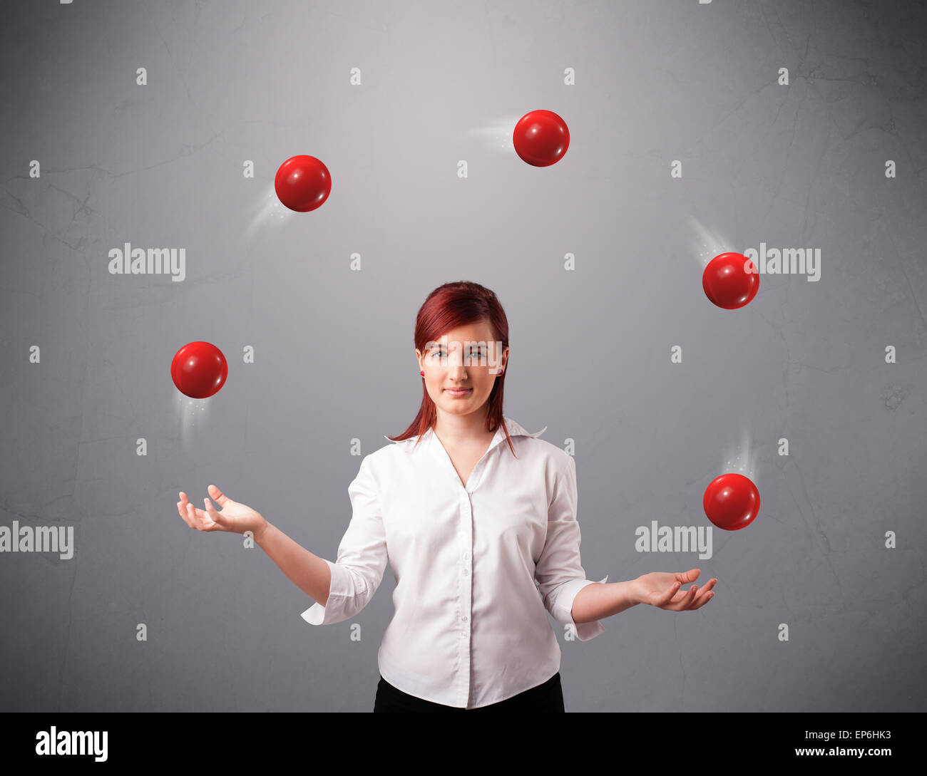 young girl standing and juggling with red balls Stock Photo - Alamy